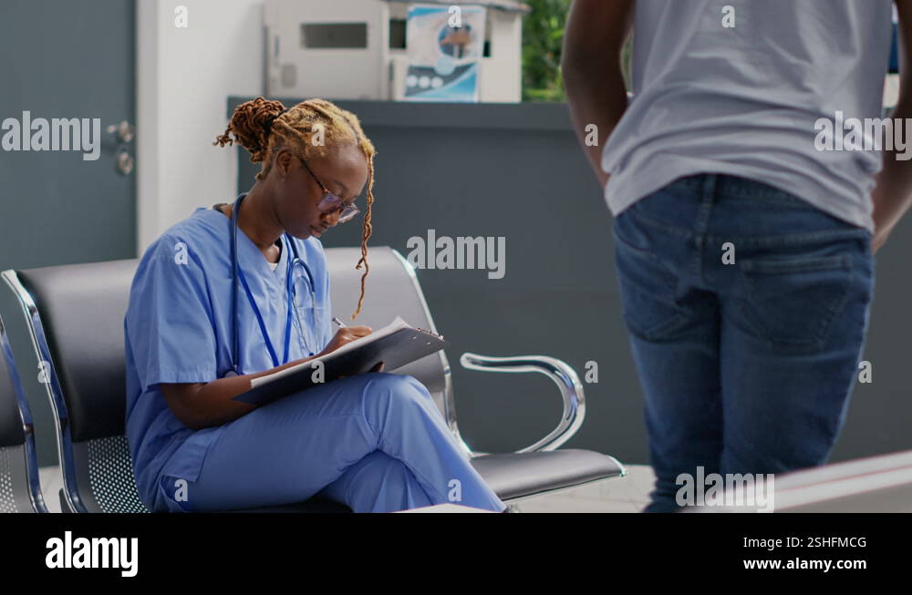 Female nurse reading medical reports papers in waiting room Stock Video ...