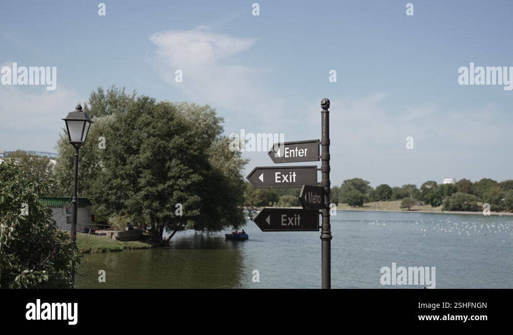 Signpost directions of entry and exit pillar on river embankment of ...