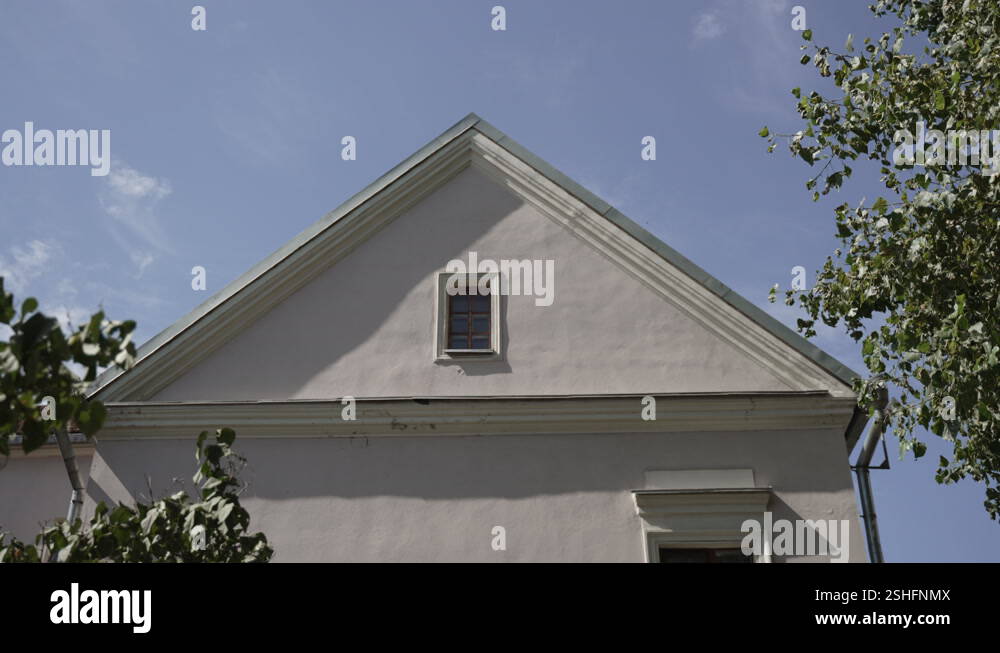 Attic of an old restored and plastered house with window and gable roof ...