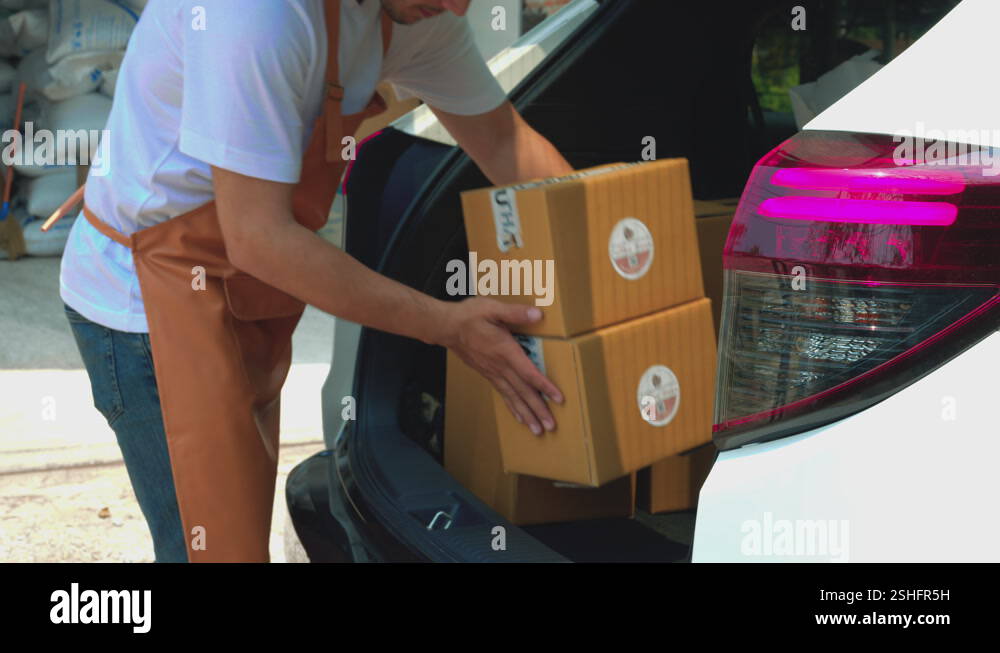 Man is delivering a package of Roasted Coffee Bean boxes in a car trunk ...