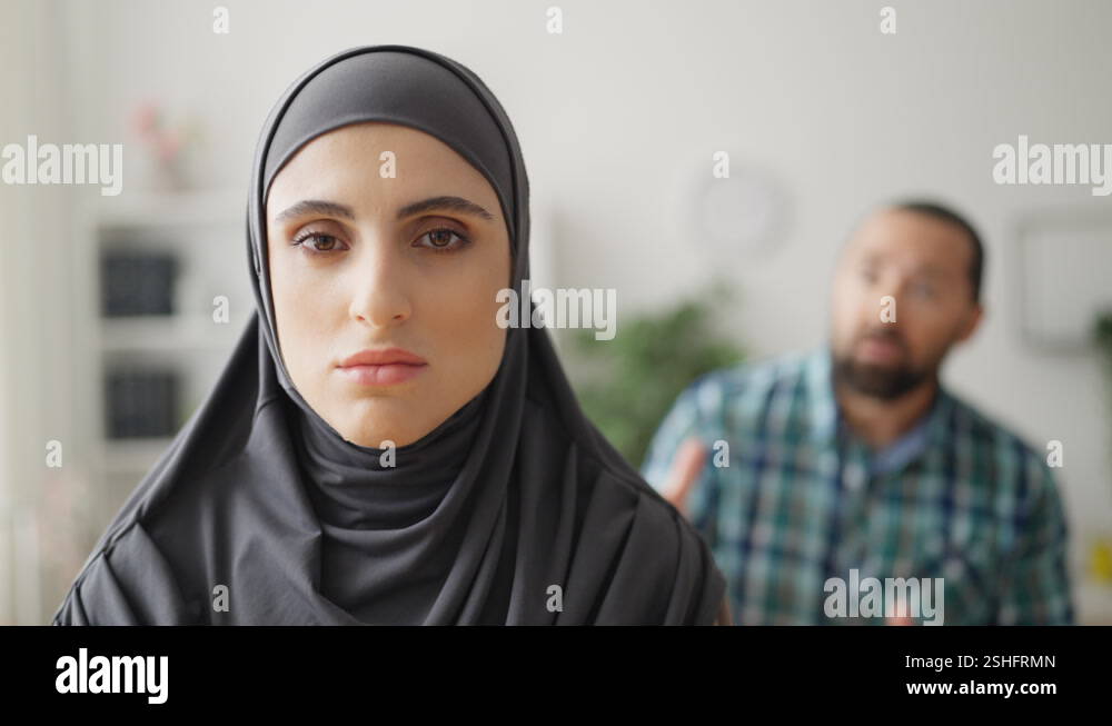 Middle-aged muslim man screaming at his wife in hijab, verbal abuse ...