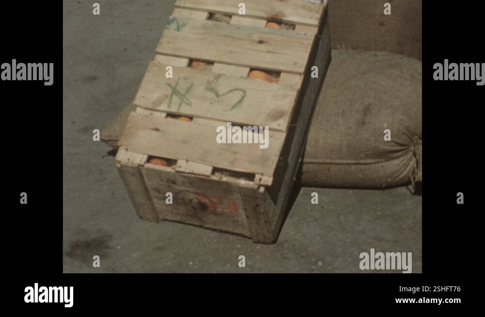 1940s: Man carries parcel. Man places parcel on the ground. Men in boat ...