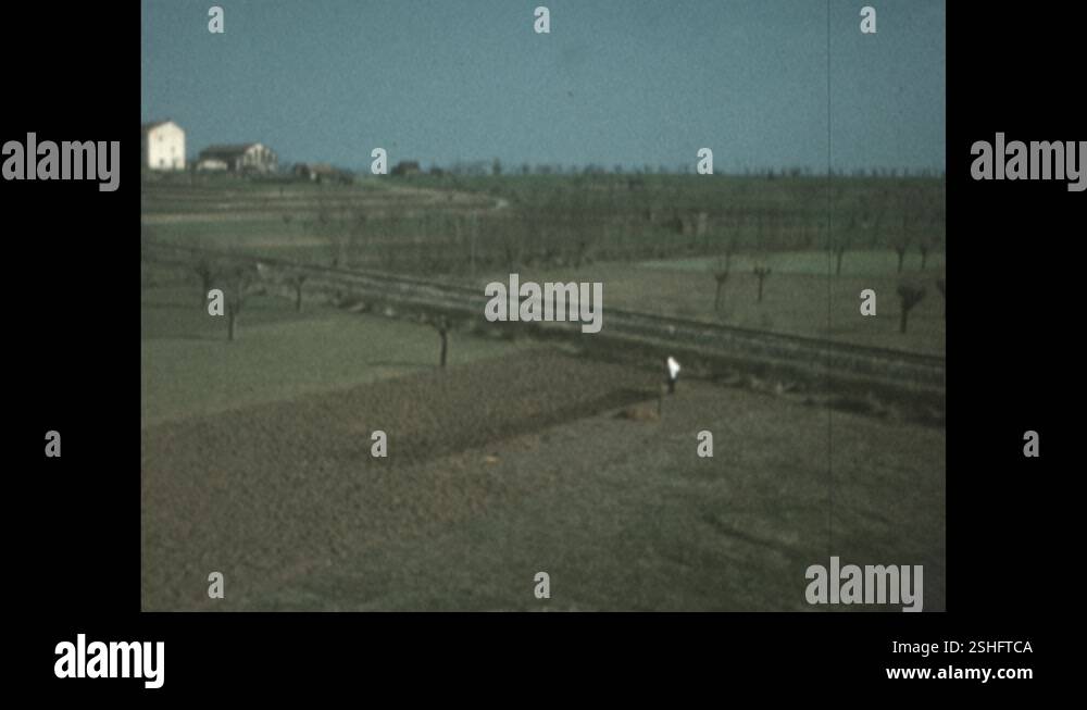 1940s: Pan of railroad track and field. Man walks across field Stock ...