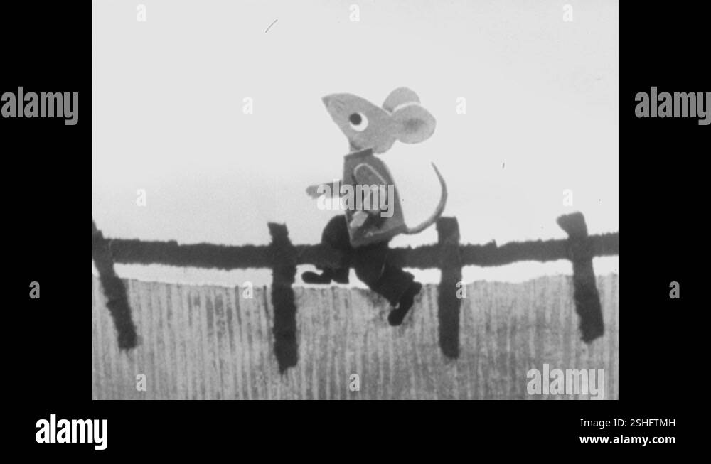 1960s: Animation. Mouse swings on vine and lands on fence. Mouse calls ...