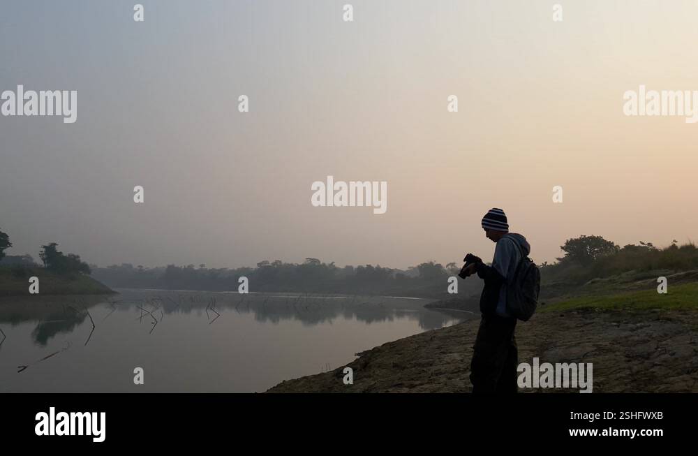 Photographer capturing polluting river, hazy polluted sky, Bangladesh ...