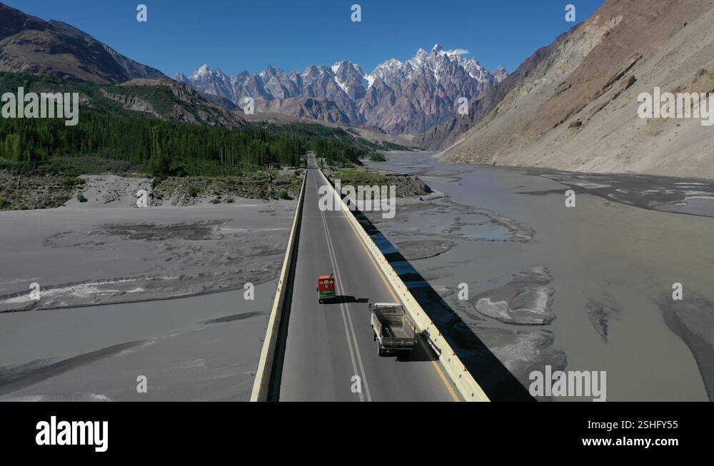 Aerial view following an auto rickshaw crossing a bridge in the scenic ...