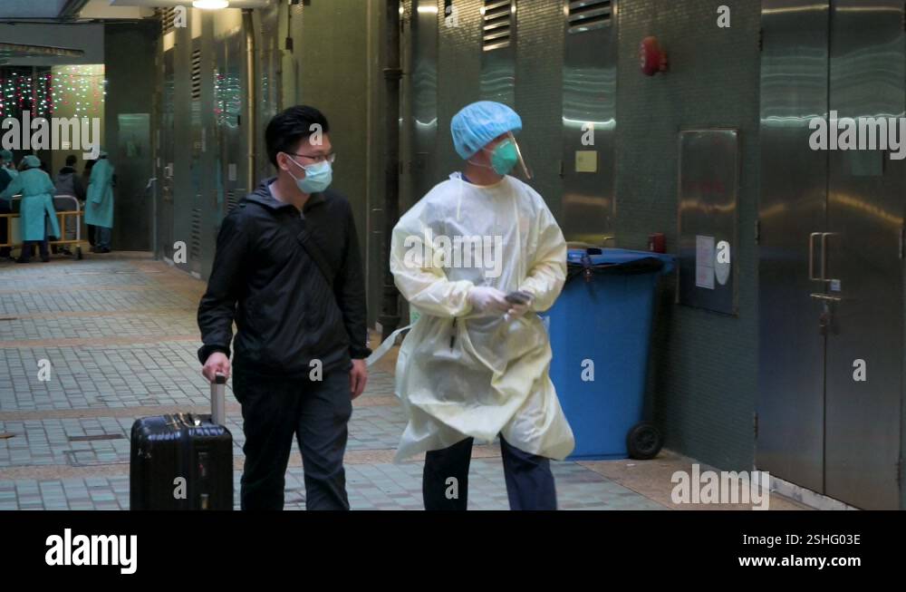 A Chinese resident follows a health worker as the public housing ...