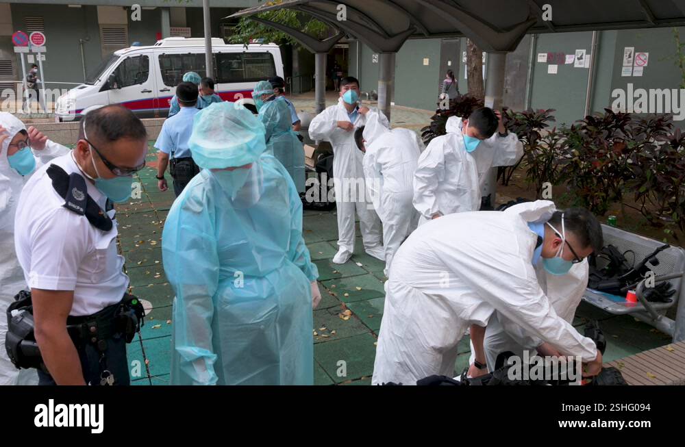 Police officers wear personal protective equipment (PPE) outside a ...