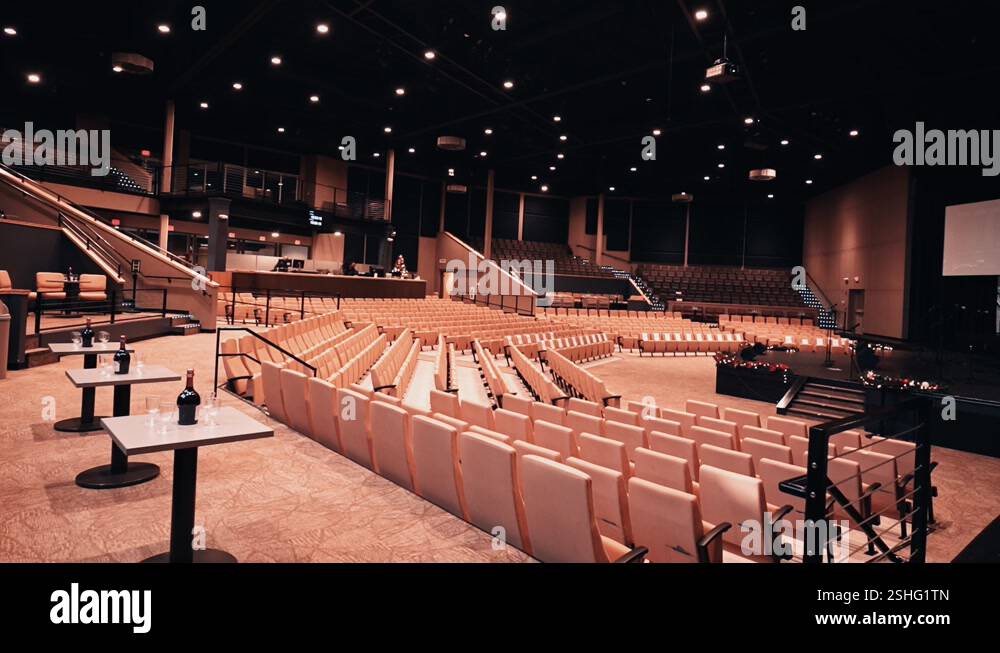 zooming in a empty venue from V.I.P area. Yellow Box church in ...