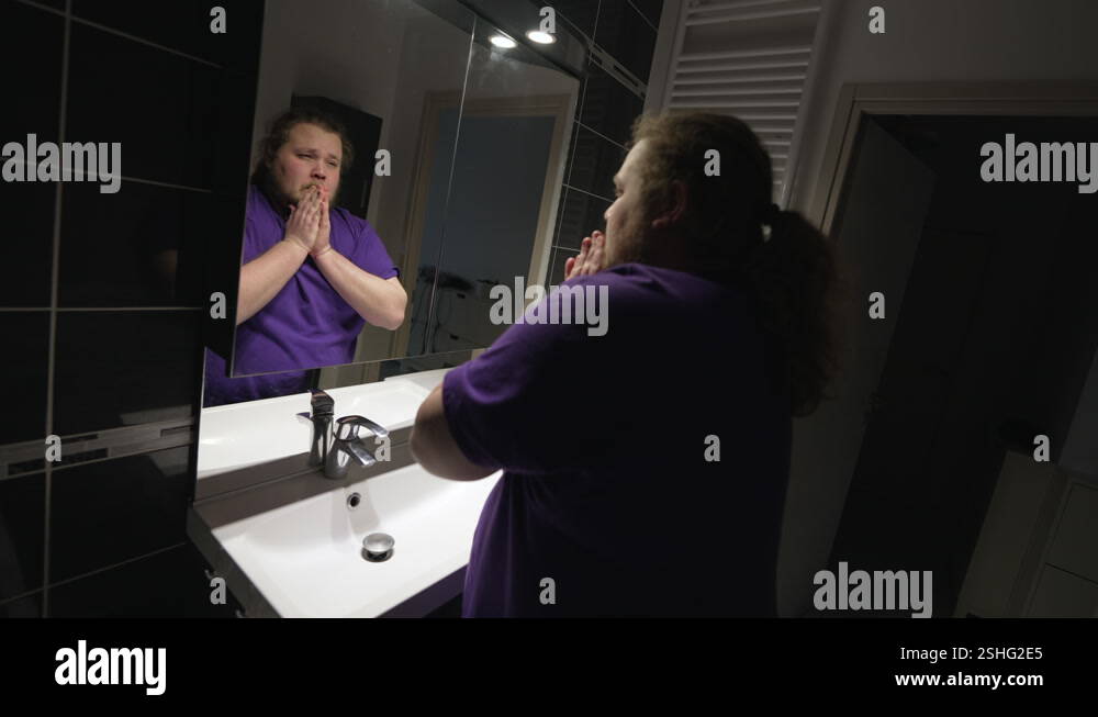 Confused sad man leaning on bathroom sink in dilemma and doubt. Person ...
