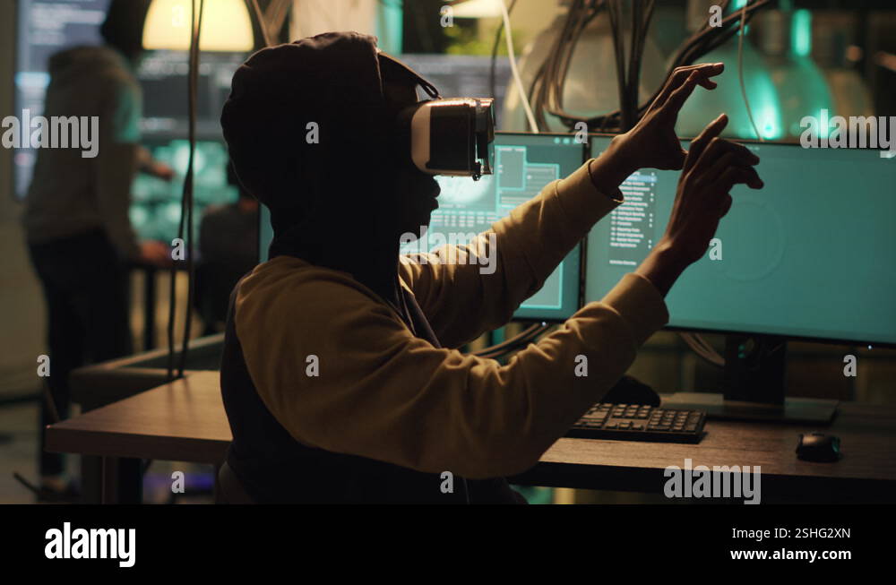 Cyber criminal using virtual reality haeadset to hack computer firewall ...