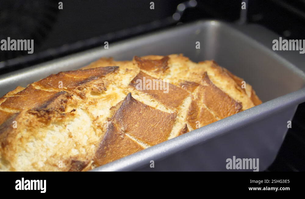 Close up shallow focus of a loaf of fresh bread baking in the oven ...