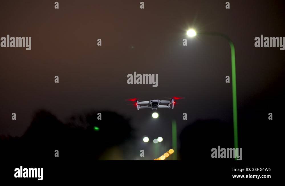 Drone flying in mid air. Unmanned aerial vehicle with blinking warning ...
