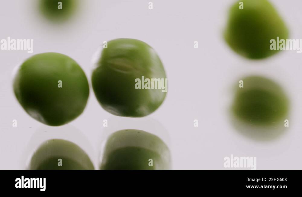 Many ripe green peas rolling on an isolated white background Stock ...