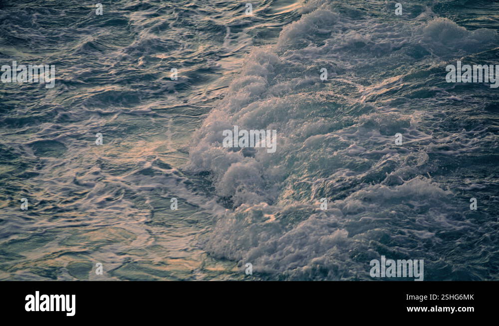 Swirling ocean foaming at morning nature closeup. Waves breaking at ...