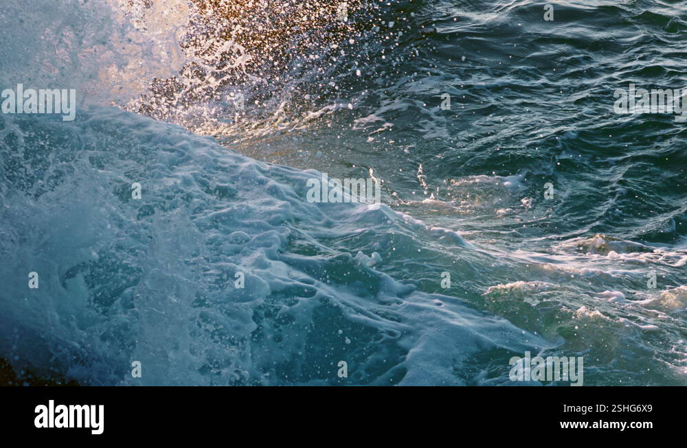 Foamy wave breaking coast outside closeup. Wild water crushing ...