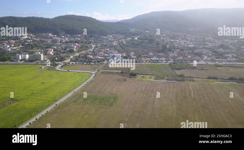 A small town with the same brown houses and roofs, through which a wide ...