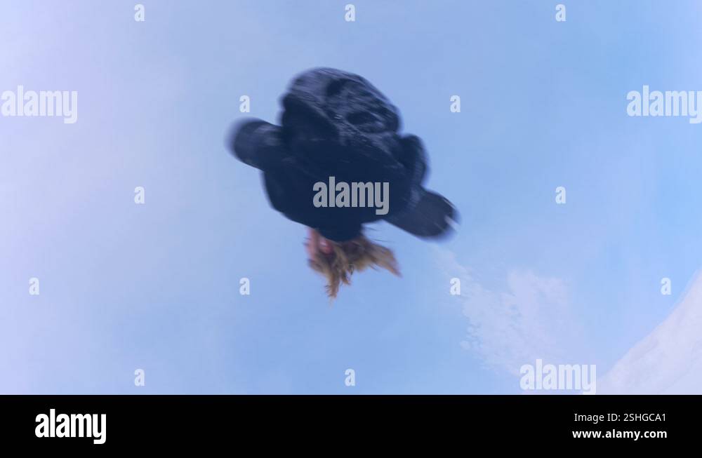 Snowboarder doing a frontlfip and backflip over camera in slow motion ...