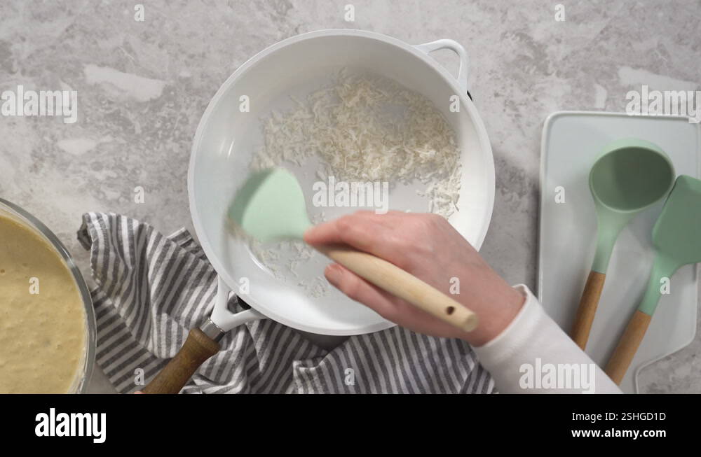 Flat lay. Step by step. Toasting coconut flakes on a nonstick white ...