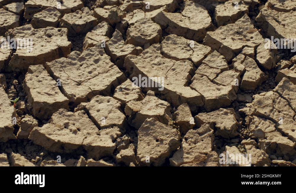 Heavy rain pouring on dry cracked soil, water saving land from drought ...