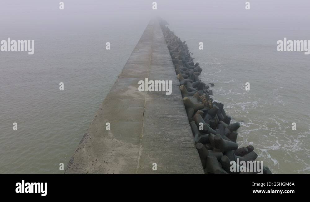 Aerial establishing view of Port of Liepaja concrete pier, Baltic sea ...