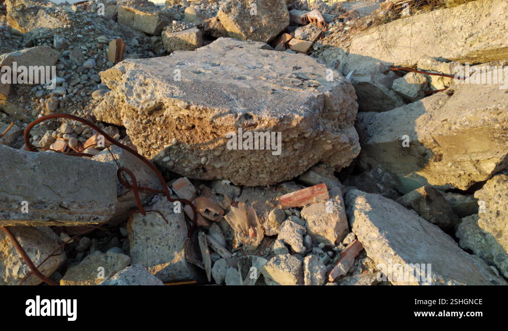 Rubble on the demolition site of a reinforced concrete building. Pile ...