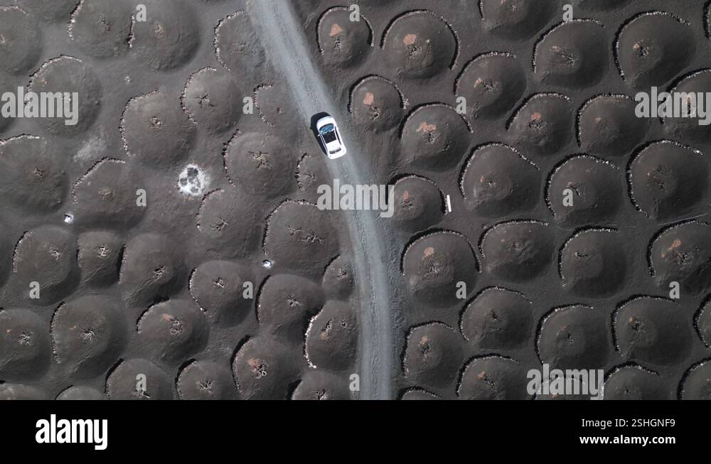 Continuous loop car on black volcano ash road Marvelous aerial view ...