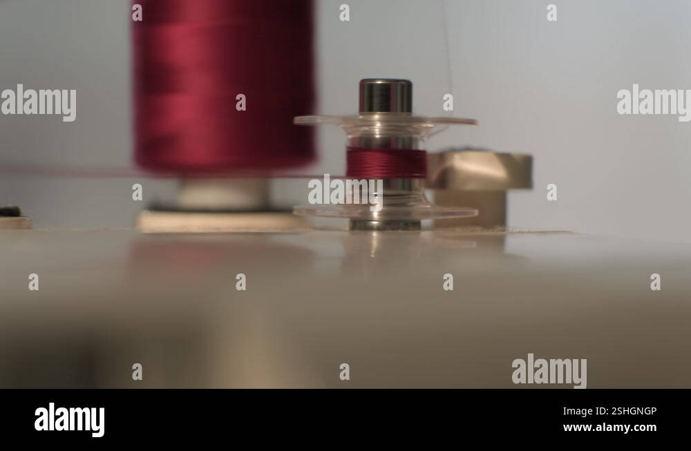 Tailor on sewing machine threads bobbin winding thread from spool Stock ...