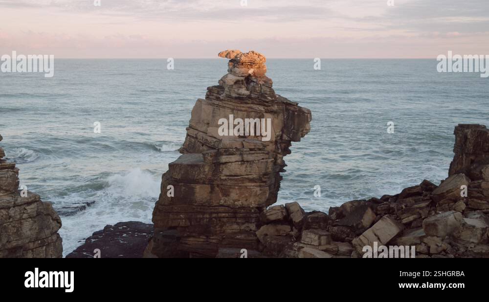 Single cliff or rock on rocky coast of Cascais in Portugal, ocean waves ...