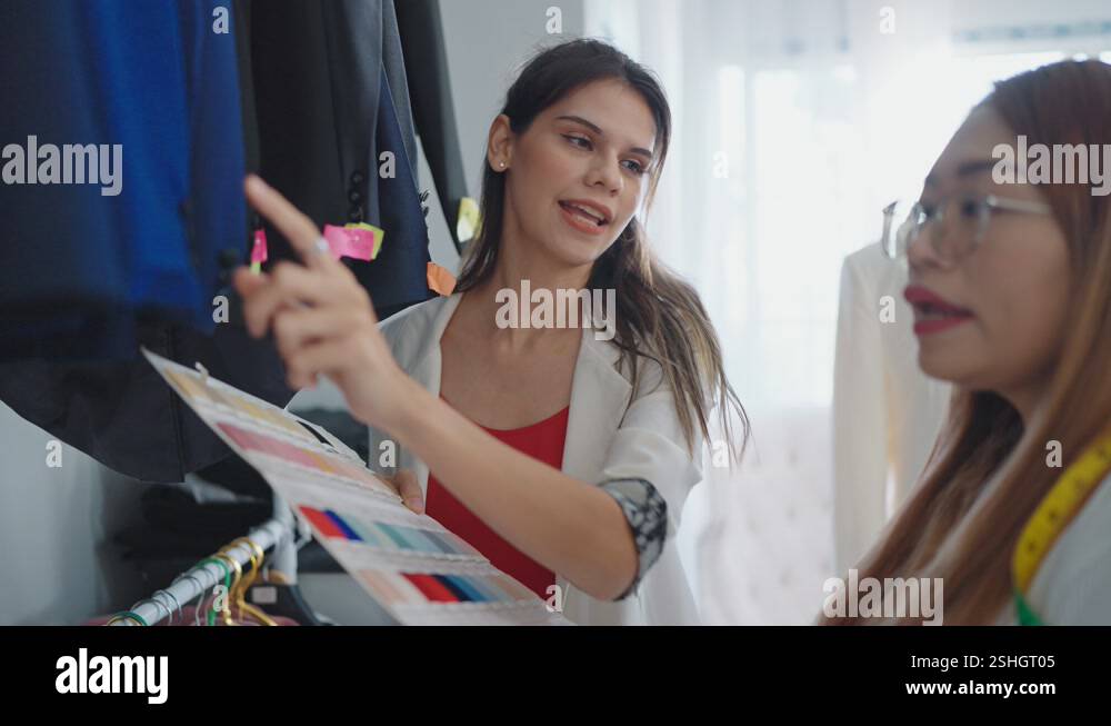 Fashion designer and assistant choosing and designing the color of the ...