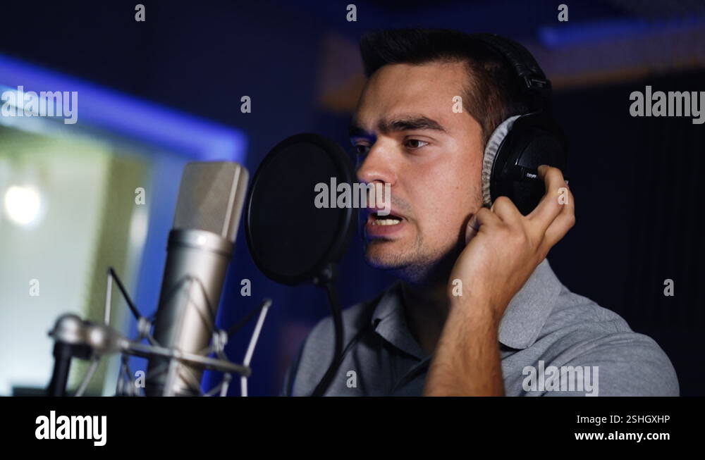 Emotional male singer performing a song in the dark studio Stock Video ...