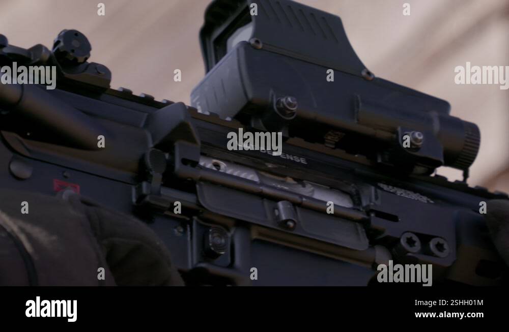 Assault rifle R20 firing bullets, ejection port closeup, bullet cases ...