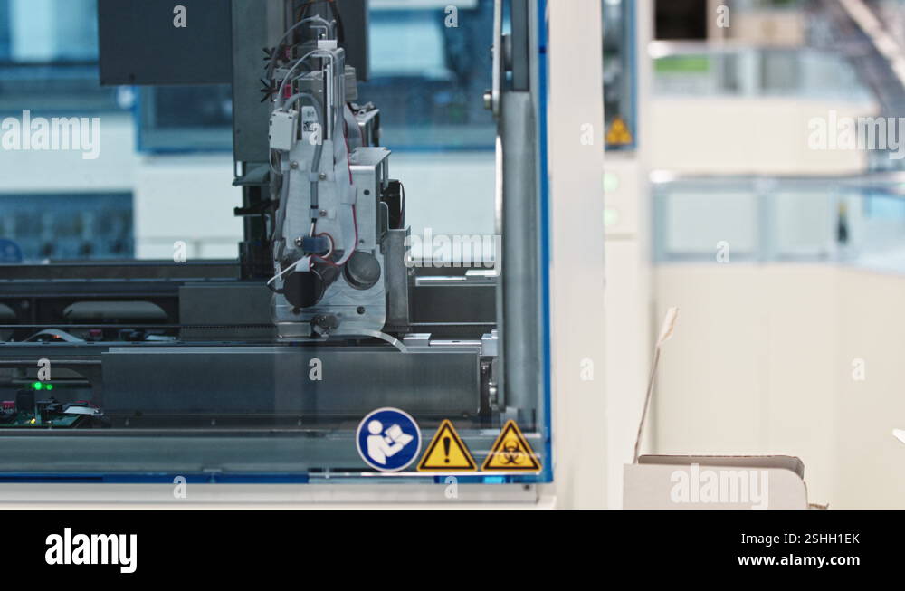 Medium shot of an automated lab glass window with a machine hand behind ...