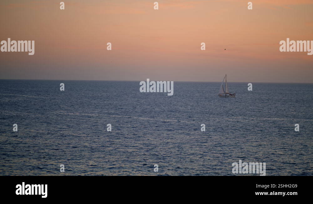 Romantic pink ocean sunset on summer vacation. White yacht sailing calm ...