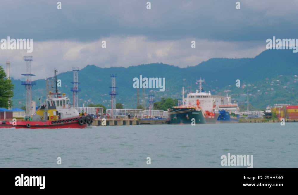 Tug boat is moving forward, sailing on the Black Sea near the cargo ...