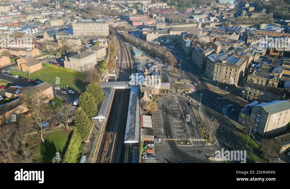 Cinematic aerial footage of a small town in England showing train ...
