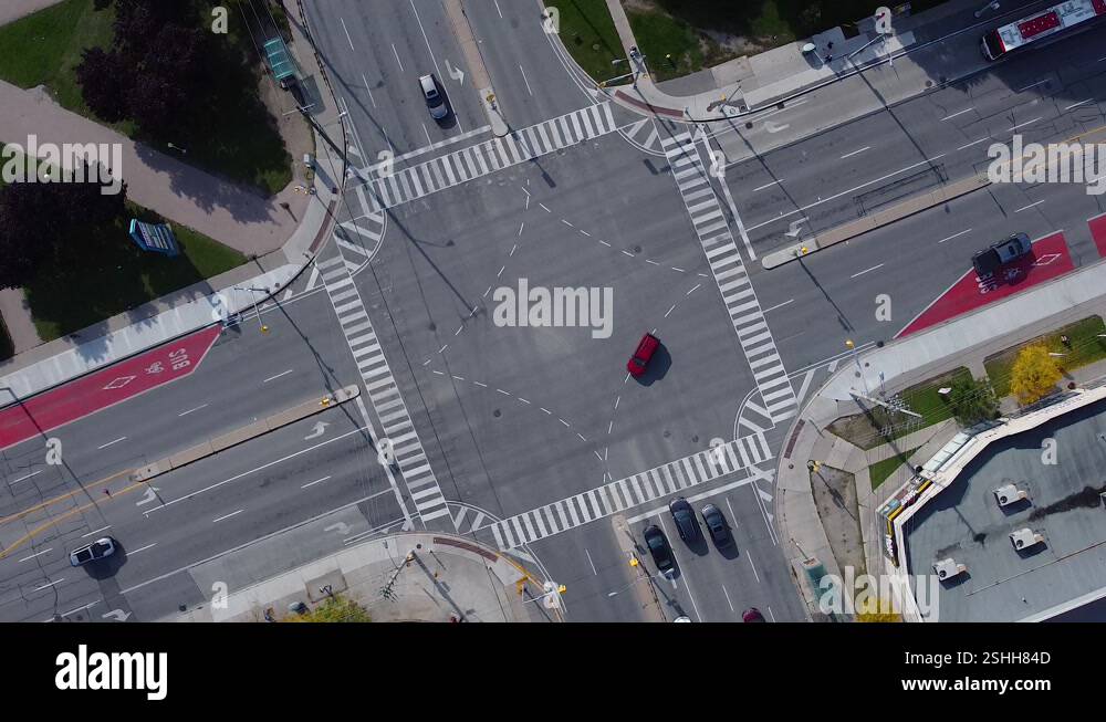 Bus lanes with buses driving through busy city intersection with cars ...