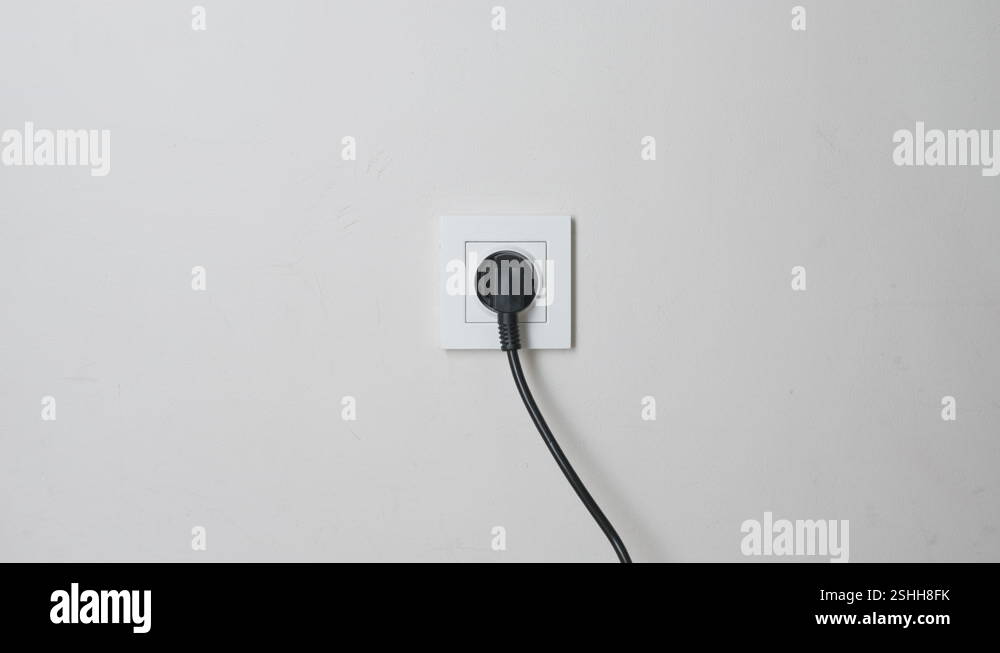 Male hand plugging unplugging charger cable plug into white wall power ...