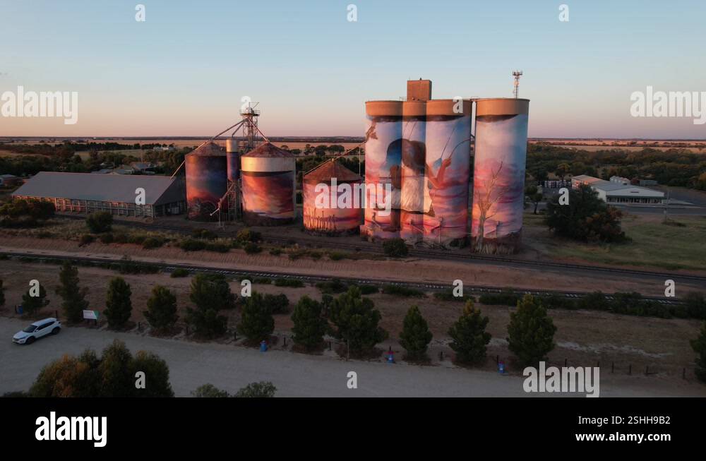 Wide shot toward colourful art silo Sea lake sunrise, Victoria ...