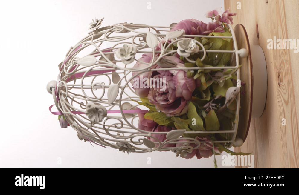 rotating decorative cage with a composition of artificial flowers Stock ...