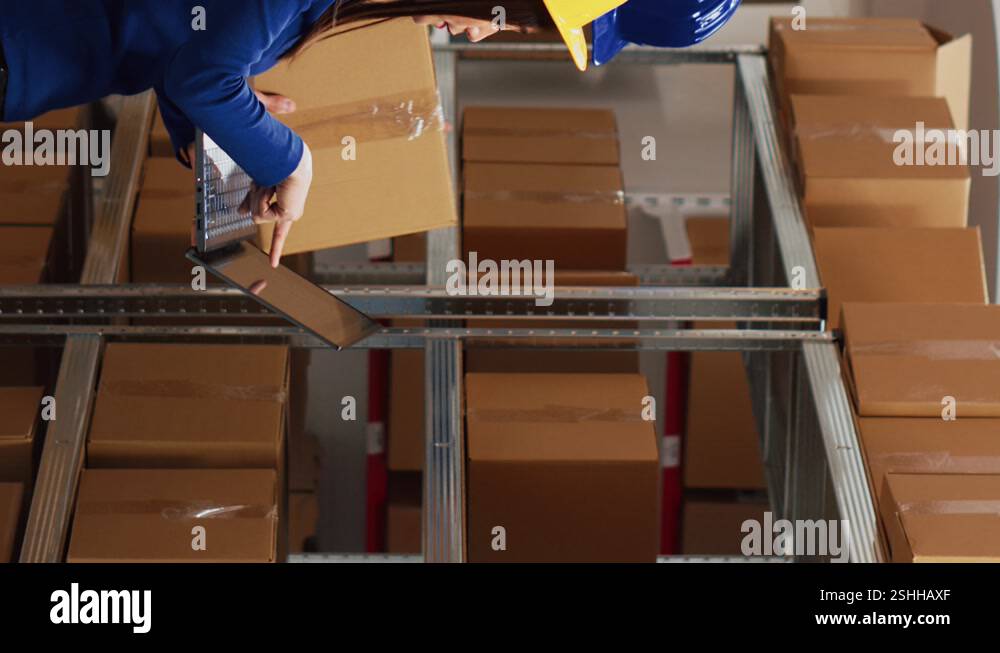 Vertical video: Young asian people looking at carton boxes on racks ...