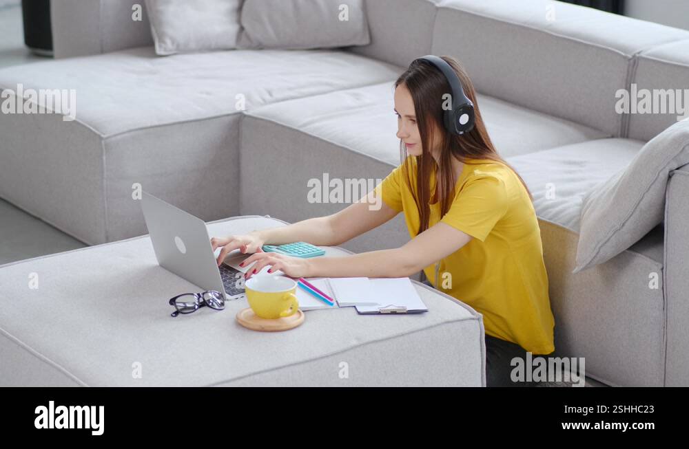 Young female professional writing an important email from her home ...