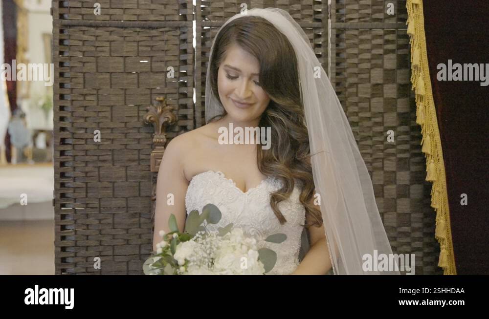 Young bride smiles as she is being photographed on wedding day. Shot in ...