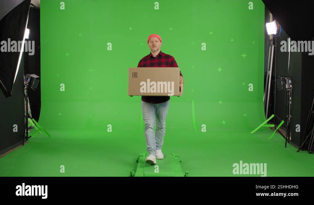 Man worker holding a box walking on Green Screen Stock Video Footage ...
