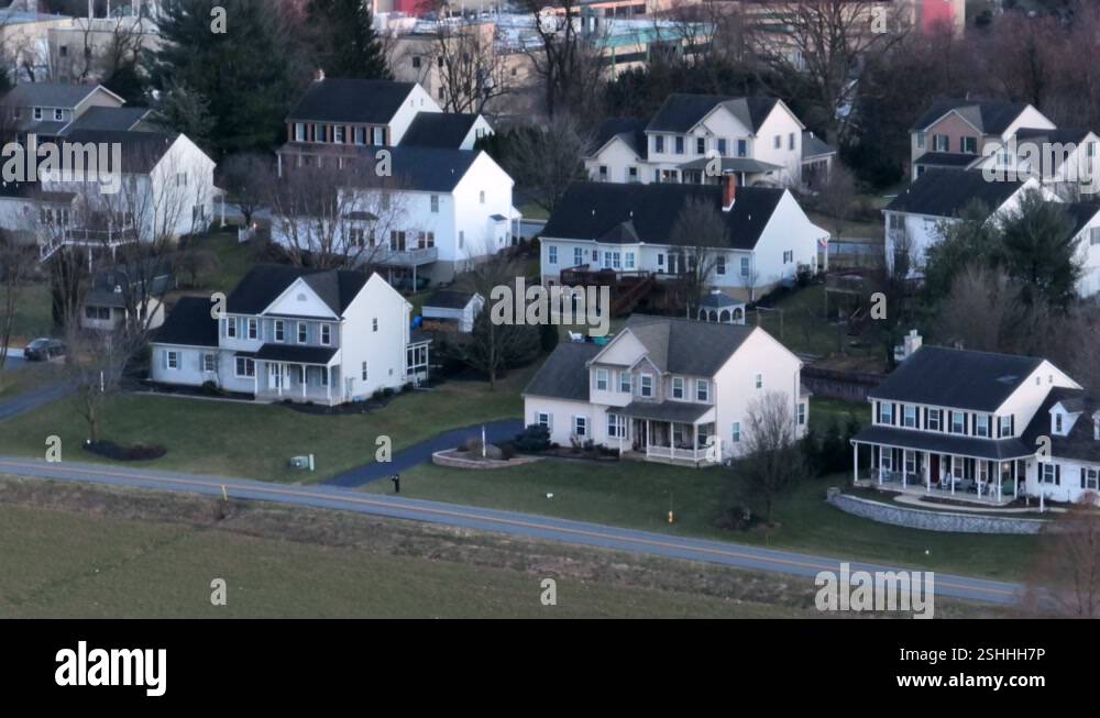 Long aerial zoom of large American homes during winter. Cold ...