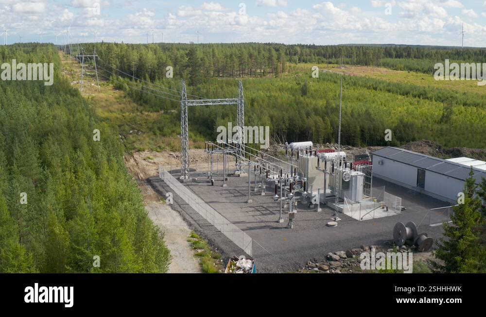 Establishing shot of an electric power station with transmission lines ...