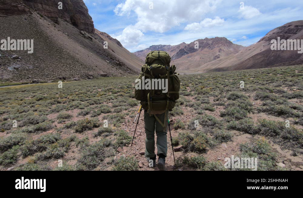 Person hiking with heavy backpack on the approach to basecamp on ...