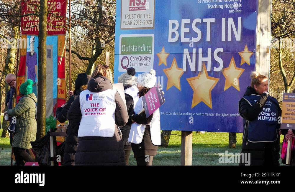 NHS nurses strike for fair pay, waving banners and picket flags outside ...