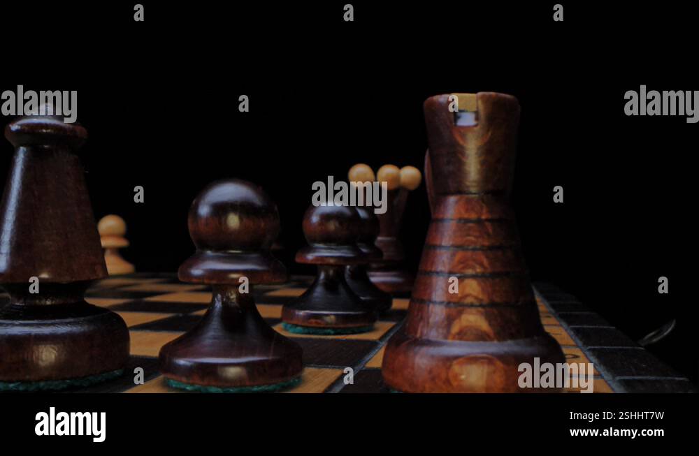 Chess game. A wooden chess pieces on a chess board in lights and ...
