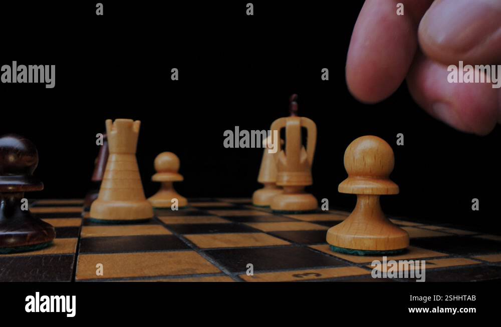 Chess game. A wooden chess pieces on a chess board in lights and ...